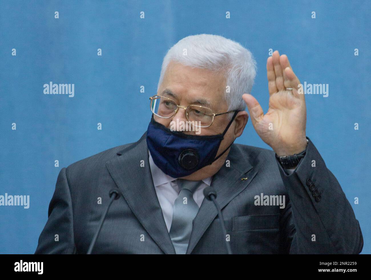 Palestinian President Mahmoud Abbas wears a mask upon his arriving to ...