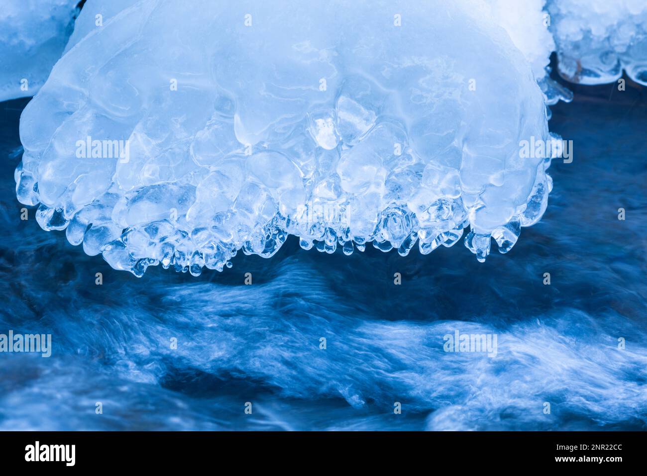 Blue icicle on small stream Stock Photo - Alamy