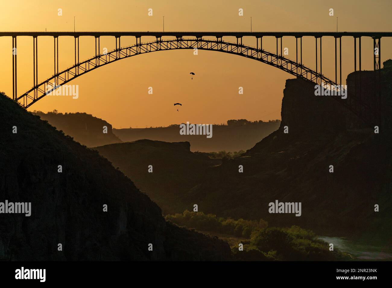 Two BASE jumpers glide below the I.B. Perrine Memorial Bridge in this ...