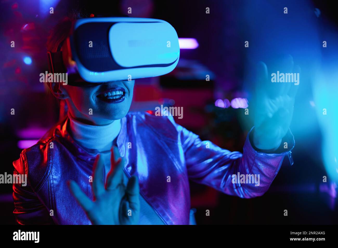 Neon metaverse futuristic concept. happy stylish 40 years old woman in ...