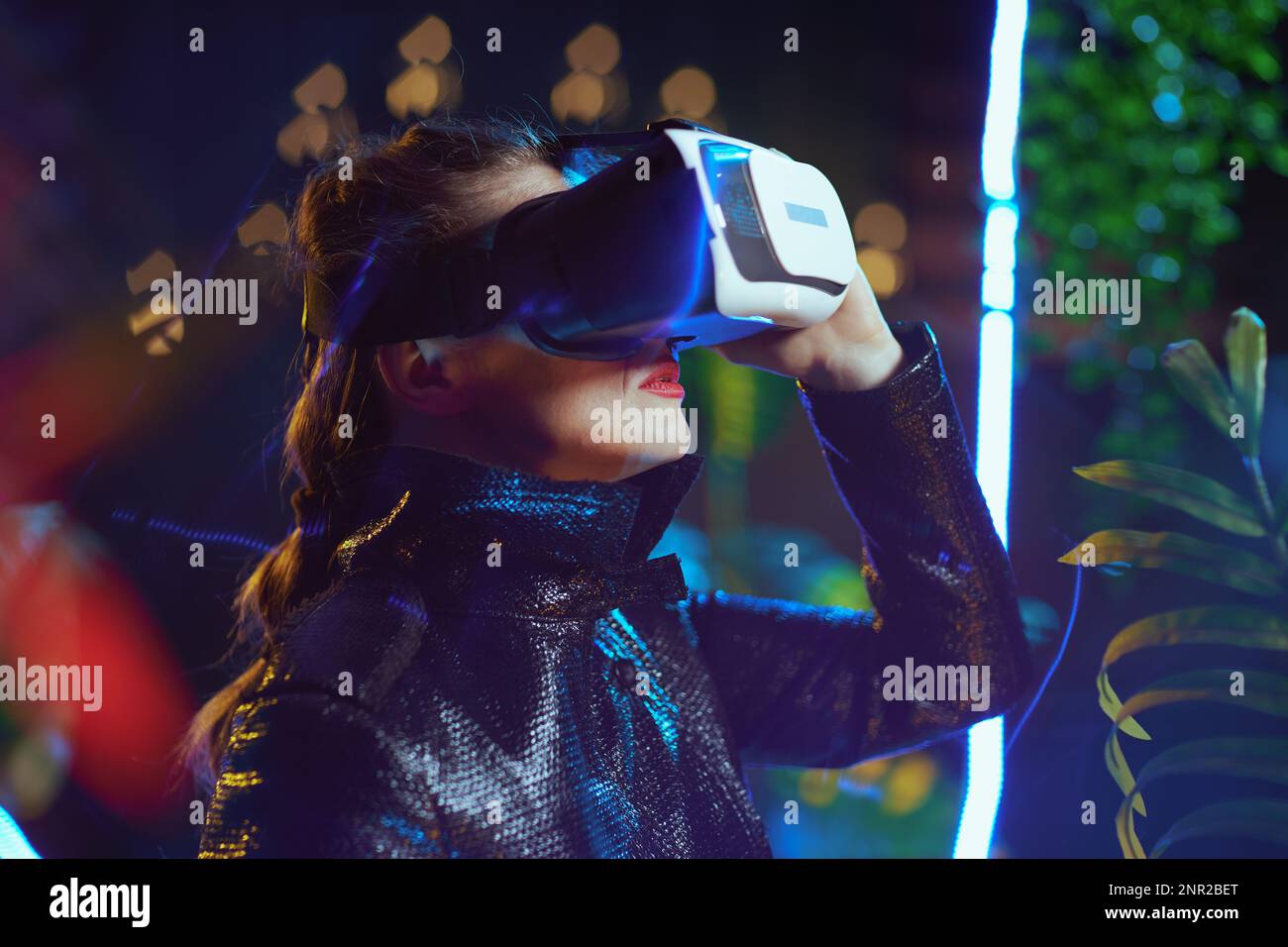 trendy female in metaverse in vr headset Stock Photo - Alamy