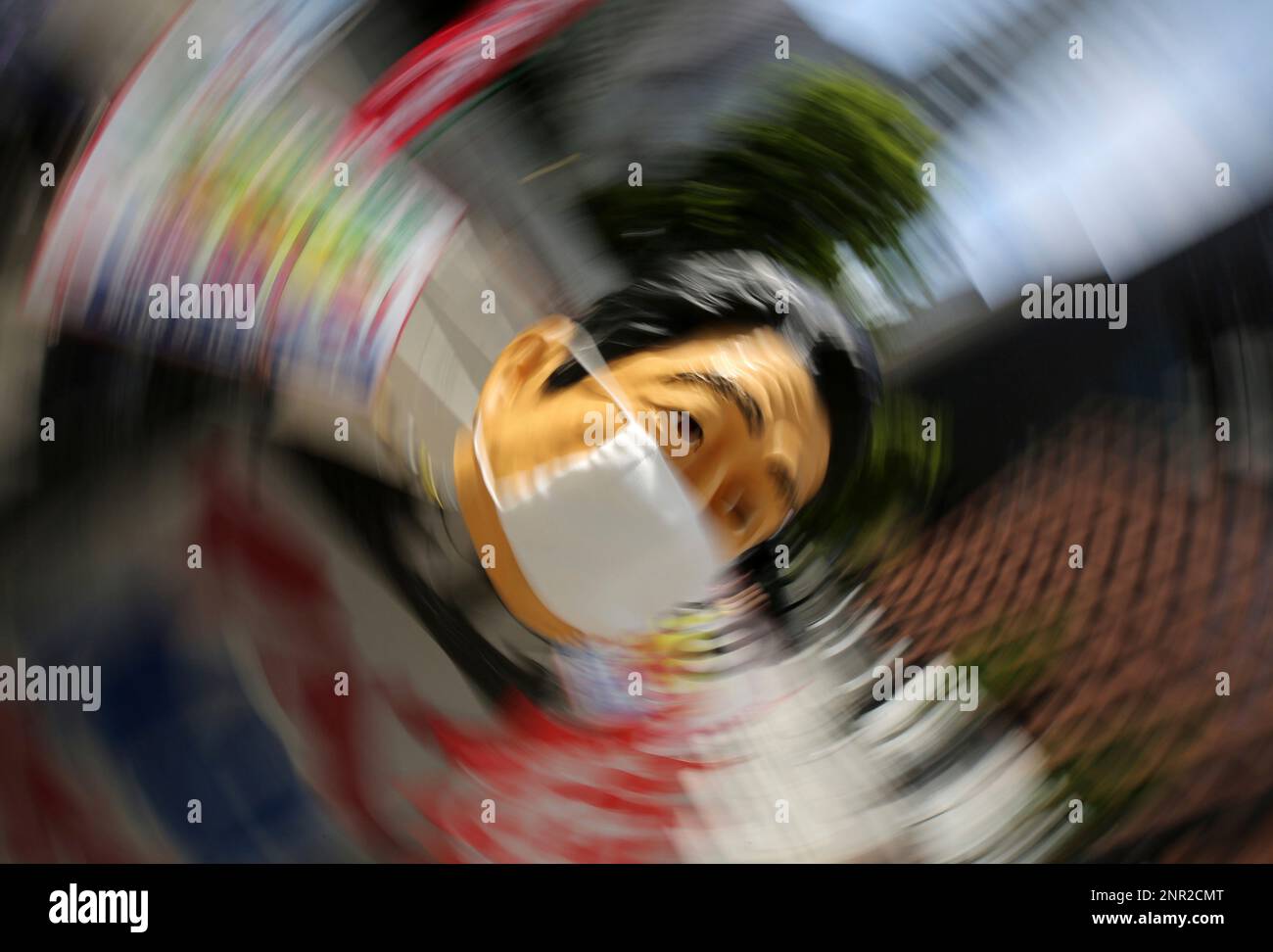 A rubber mask of Japan's Prime Minister Shinzo Abe wearing a cloth face ...