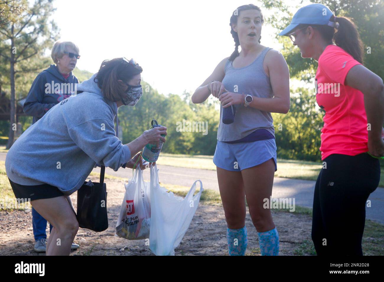 Shawna Gehres offers water and snacks to her daughter, Sarah, and ...