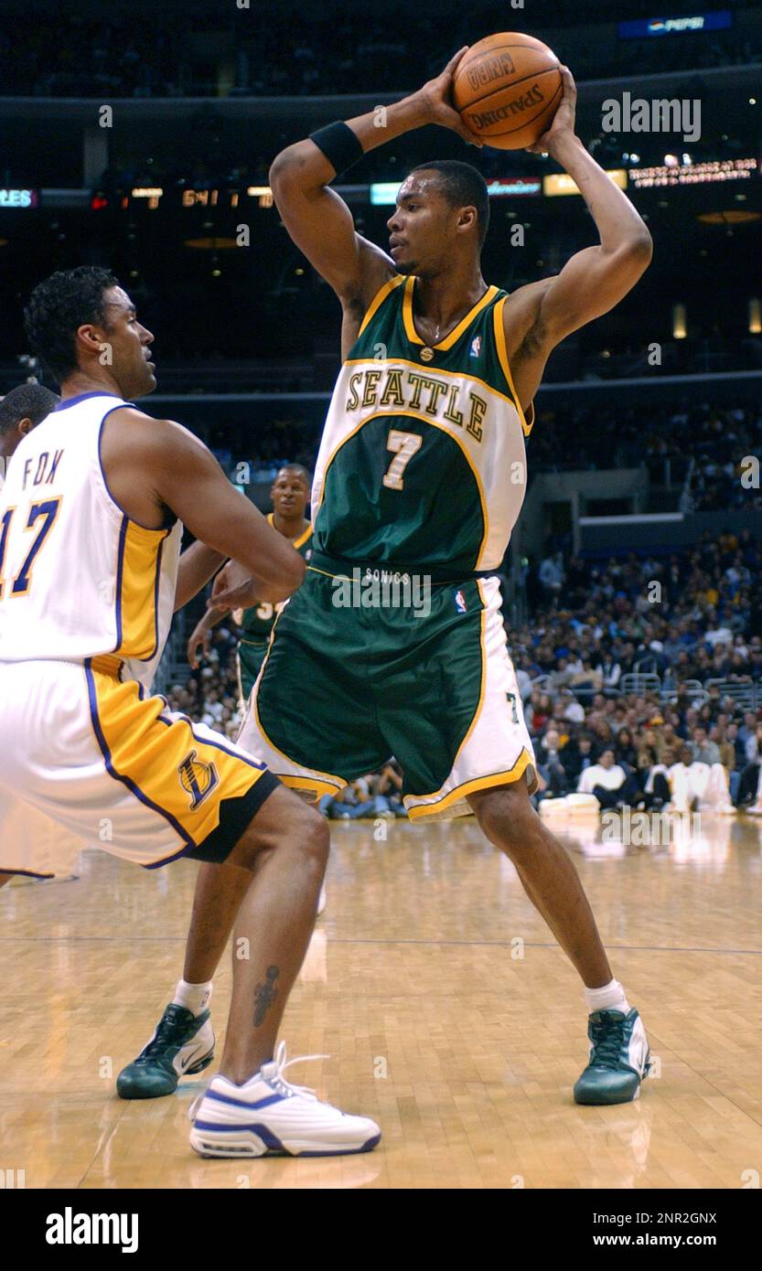 Rashard Lewis of the Seattle SuperSonics is guarded by Rick Fox of the ...