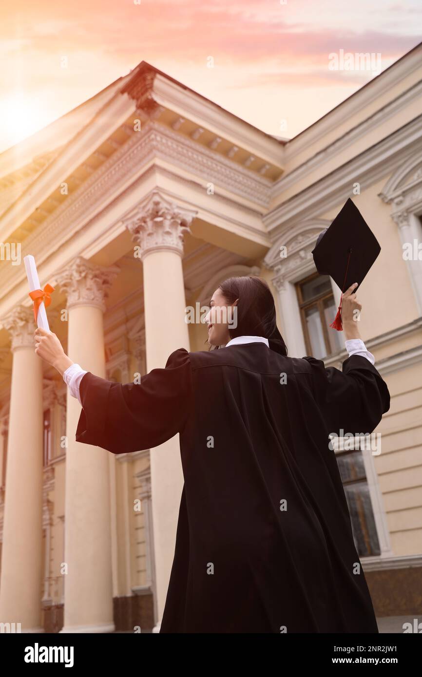 Student with diploma after graduation ceremony outdoors, low angle view ...