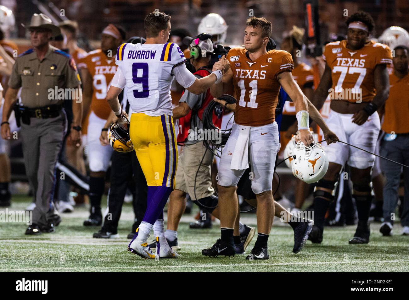 LSU Tigers quarterback Joe Burrow (9) hugs Texas Longhorns quarterback ...