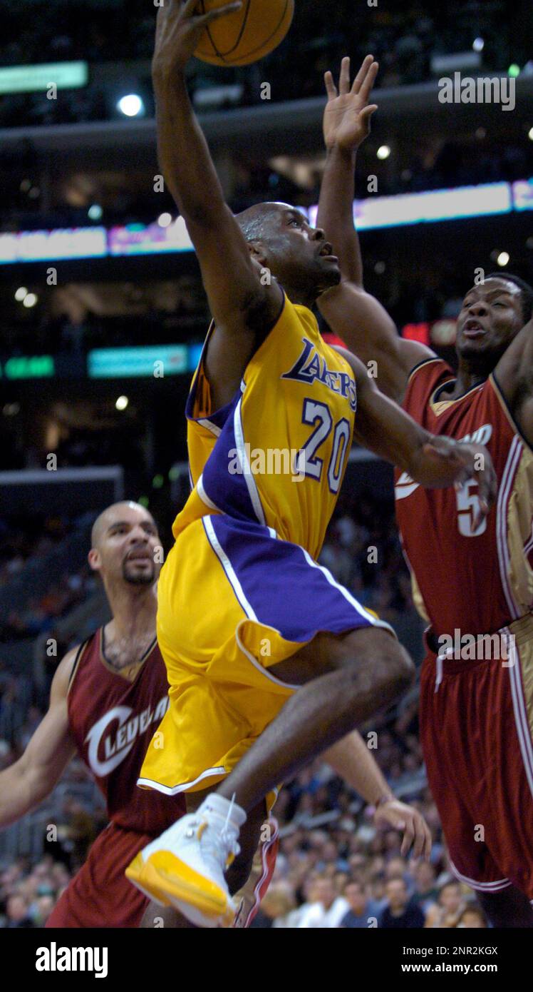 Gary Payton of the Los Angeles Lakers drives past Kedrick Brown of the ...