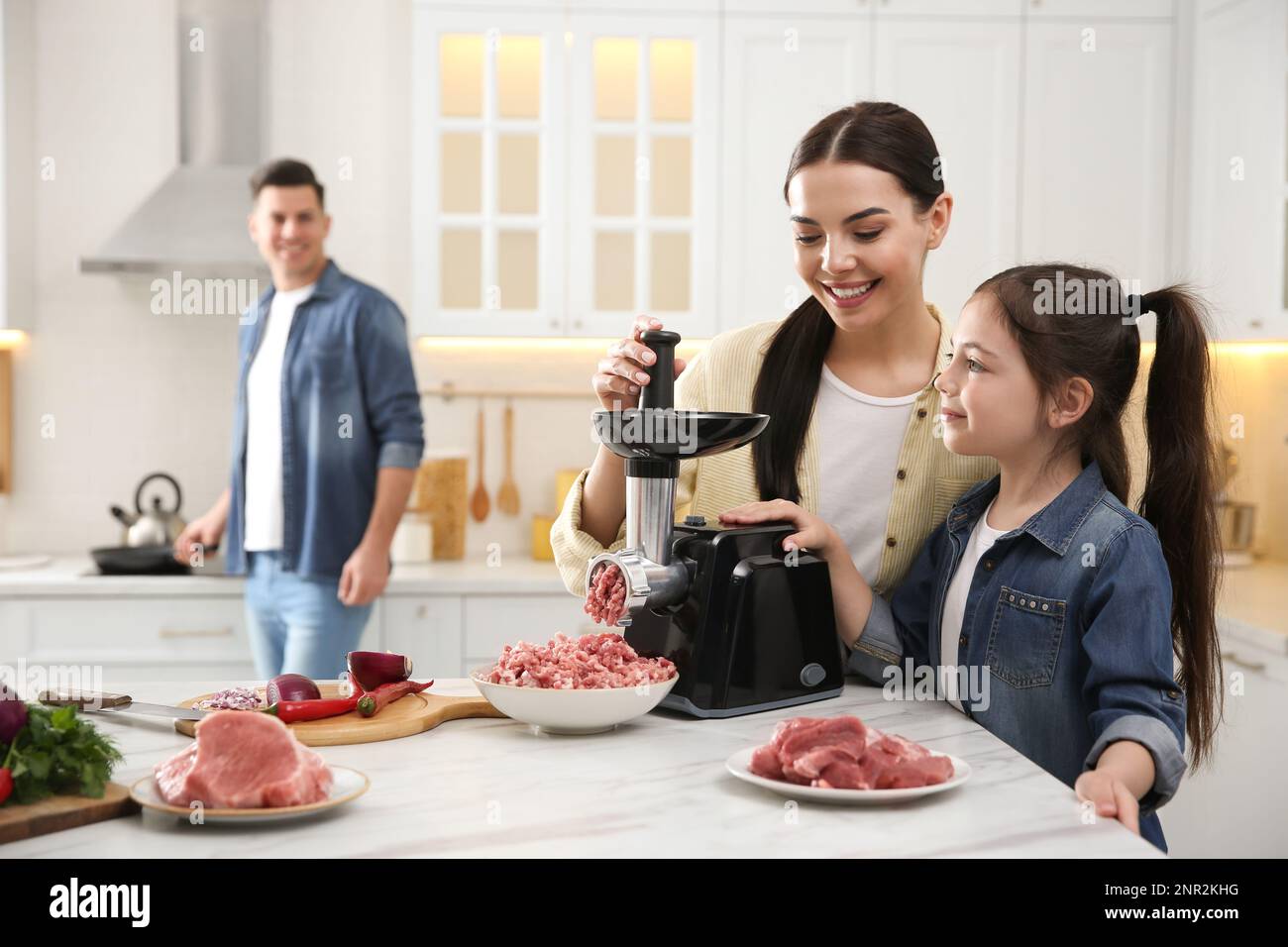 Happy family making dinner together in kitchen, mother and daughter ...