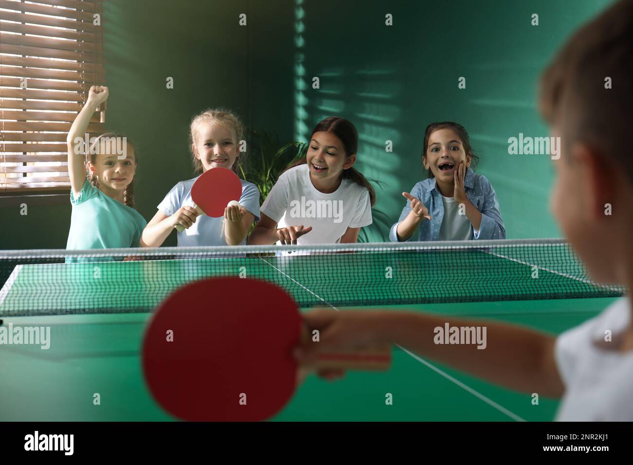 Cute girl playing table tennis hi-res stock photography and images - Alamy