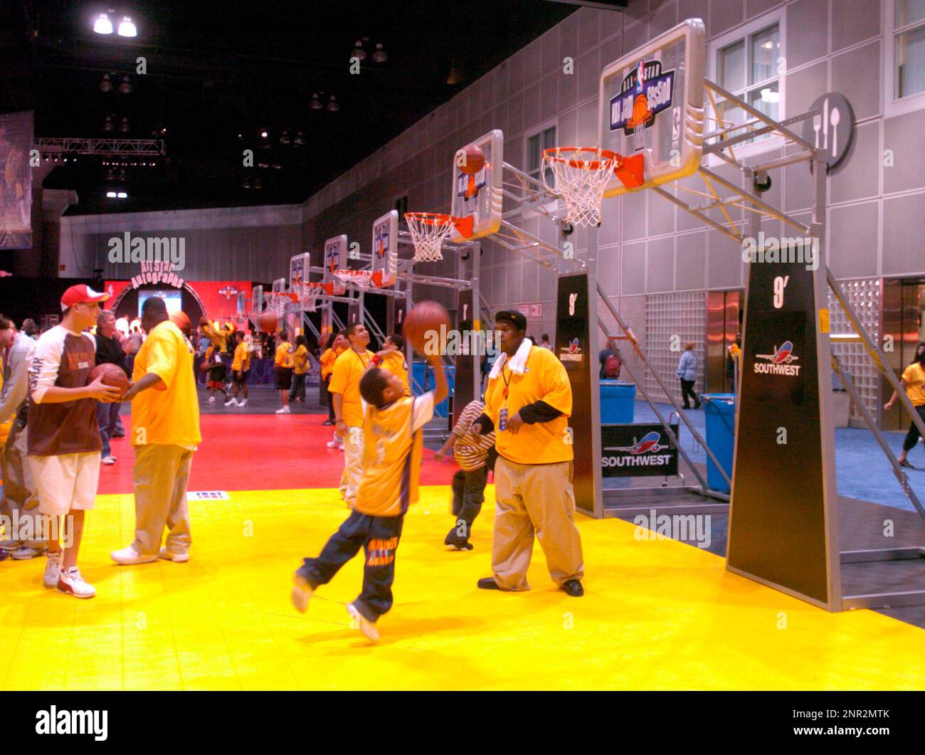 Fans shoot baskets Spero at the NBA All-Star Jam Session at the Los ...