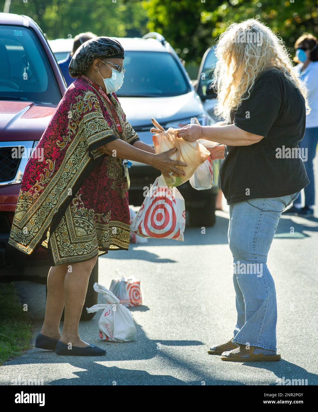 Char Lehew helps Hall Towers resident DeBorah (cq) James with her bags ...