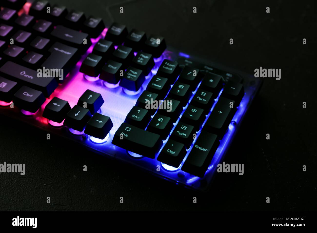 Modern keyboard with RGB lighting on black table Stock Photo - Alamy