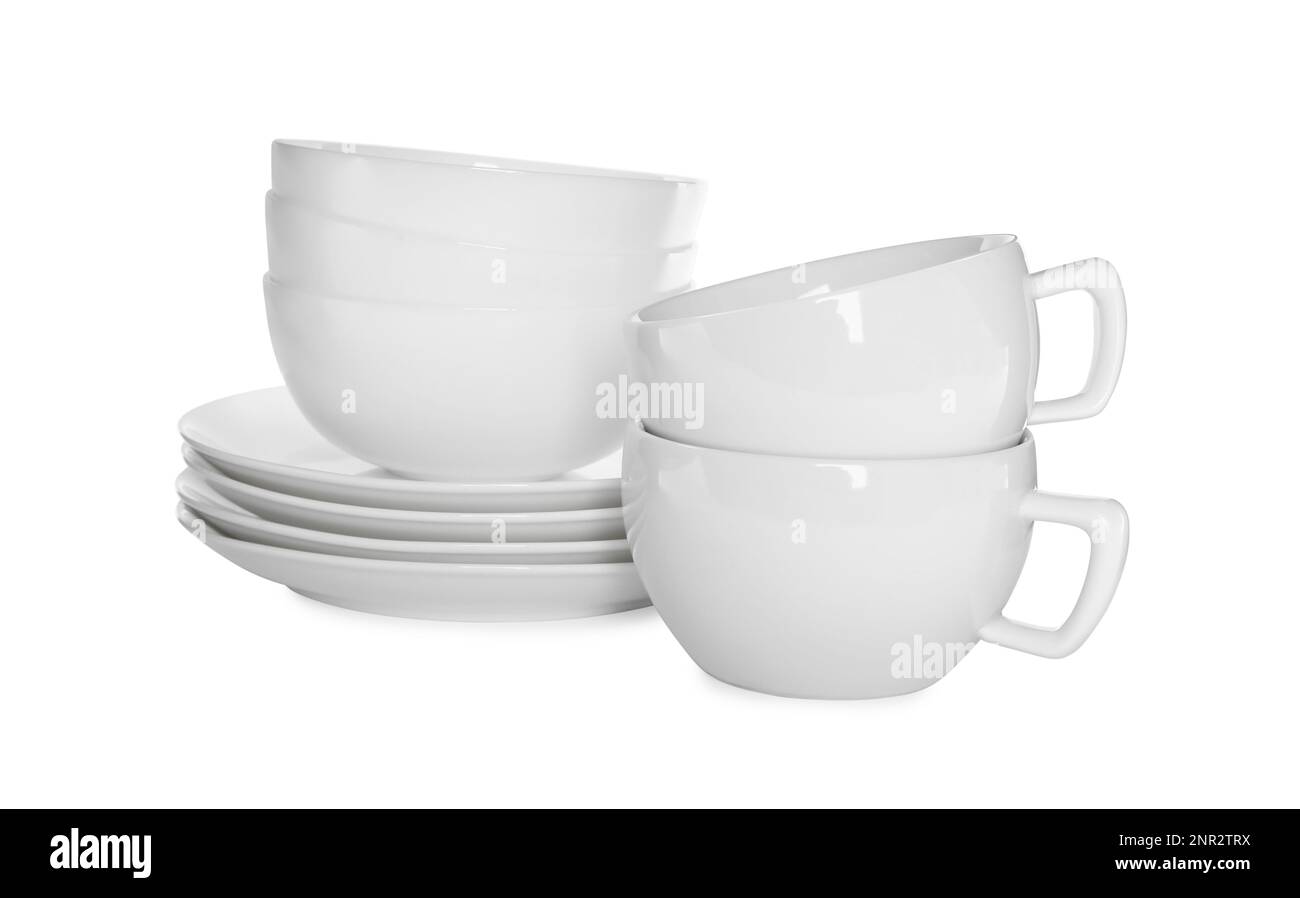 Stacked plates and cups on white background Stock Photo - Alamy