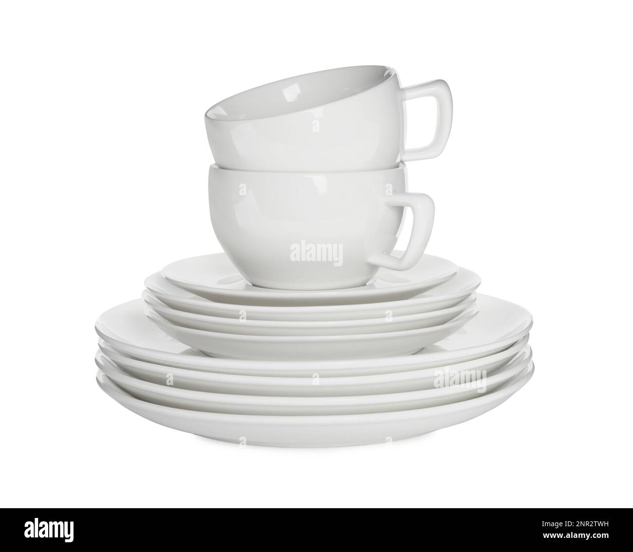 Stacked plates and cups on white background Stock Photo - Alamy