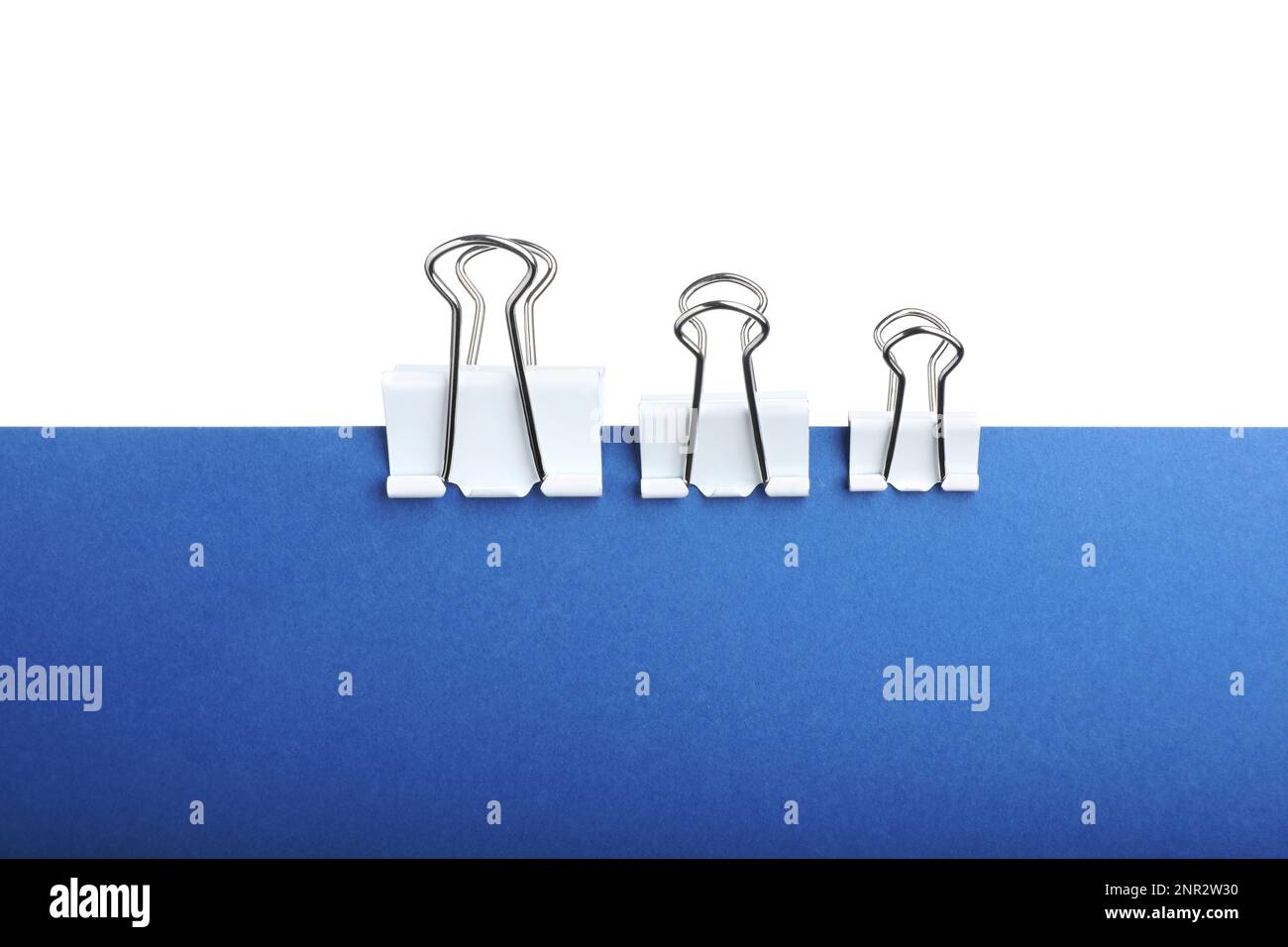 Blue paper with different binder clips isolated on white Stock Photo ...