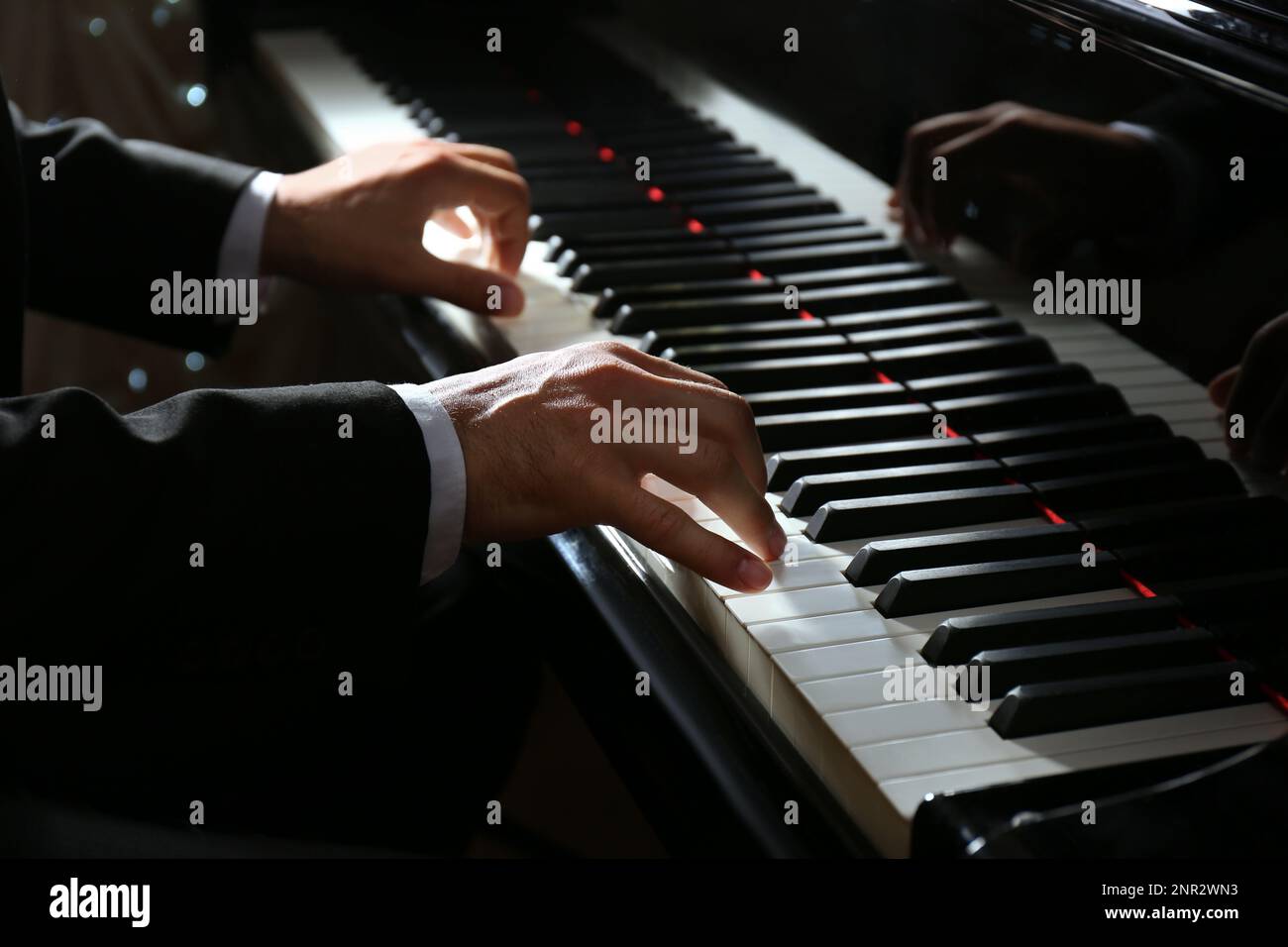 Man playing grand piano, closeup. Talented musician Stock Photo - Alamy