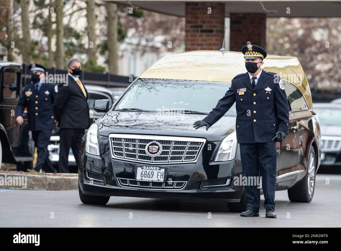 A police officer directs the hearse with the remains of officer Ronald ...