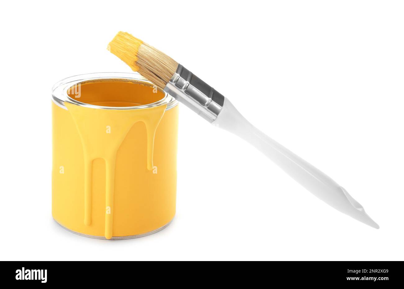 Can of yellow paint with brush on white background Stock Photo - Alamy