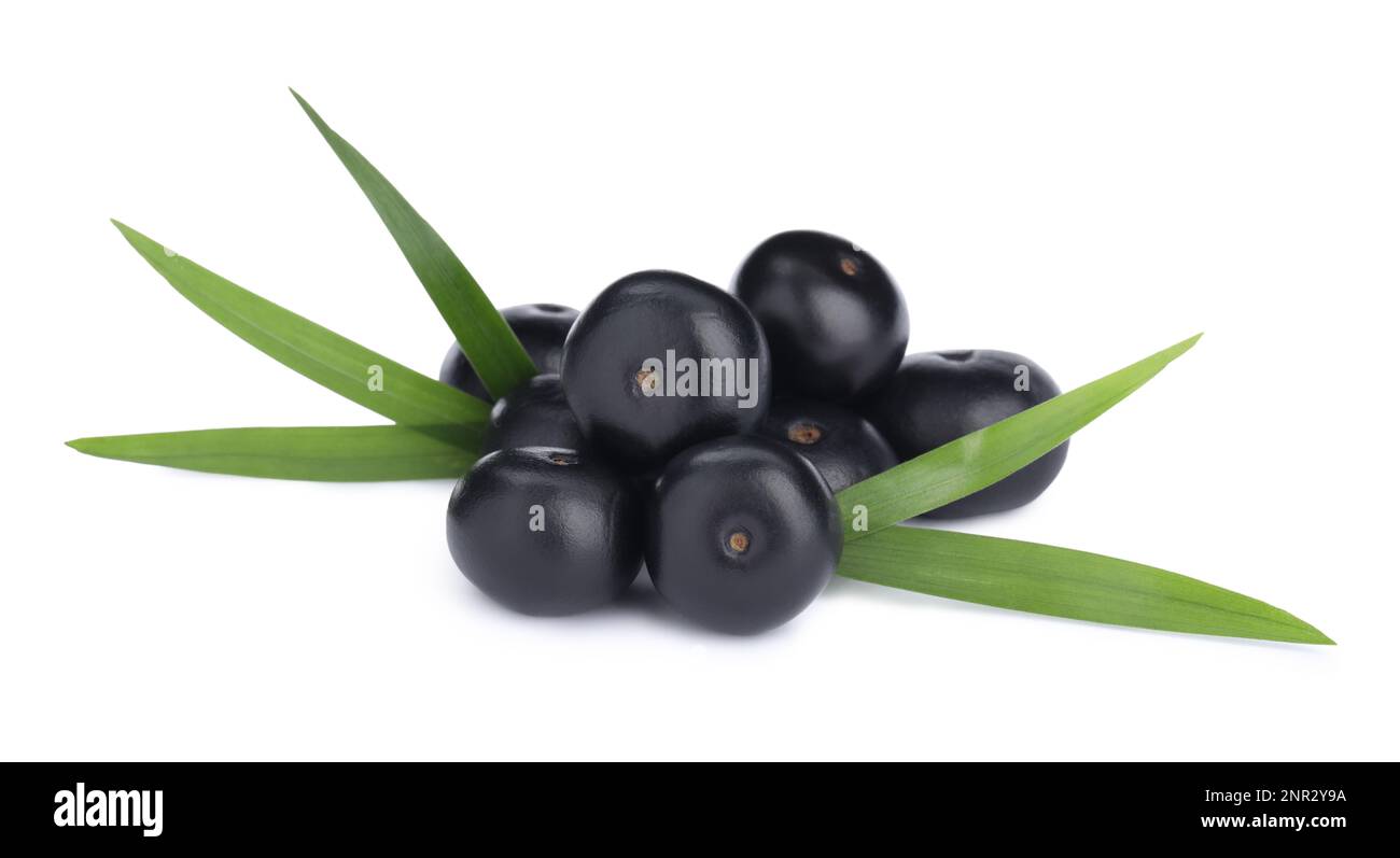 Pile of fresh ripe acai berries and green leaves on white background ...