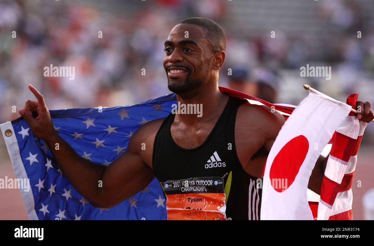Tyson Gay poses with an American flag after winning the 100 meters in 9 ...