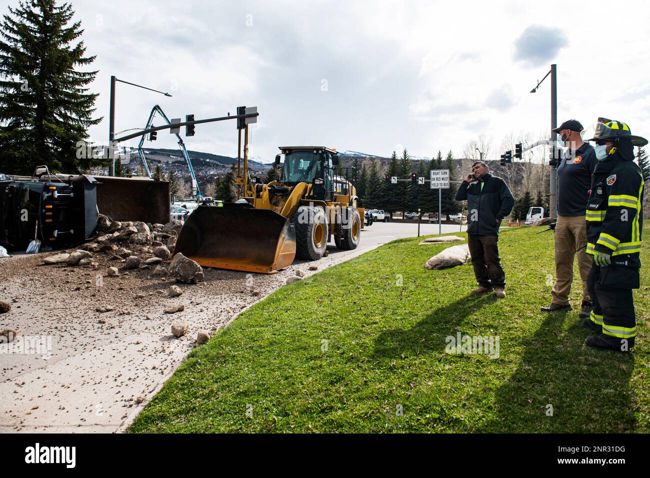 A bulldozer arrives to clean up the spilled rock after an Excavation ...