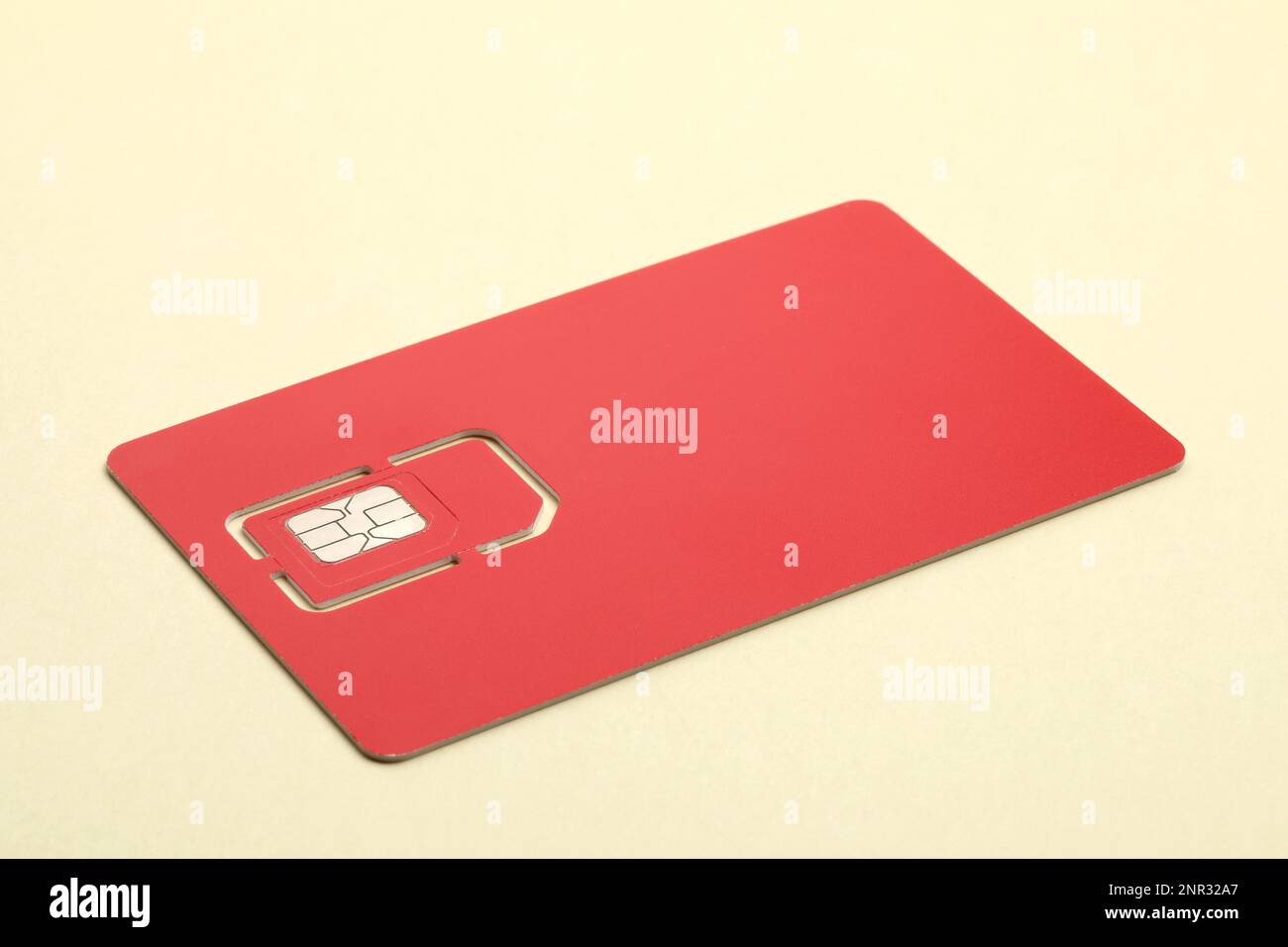 Modern red SIM card on beige background, closeup Stock Photo - Alamy