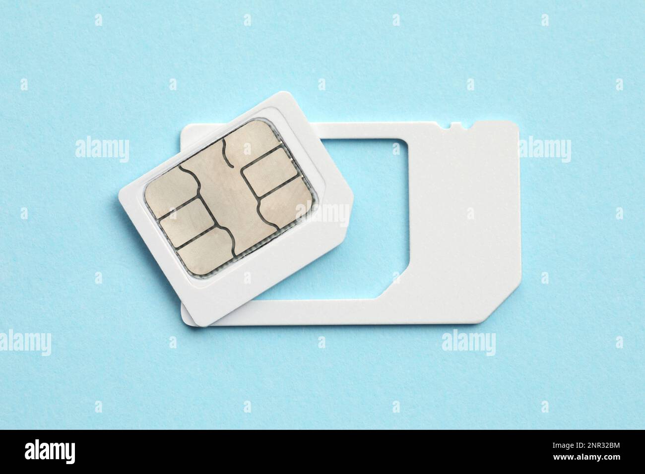 Modern SIM card on light blue background, top view Stock Photo - Alamy