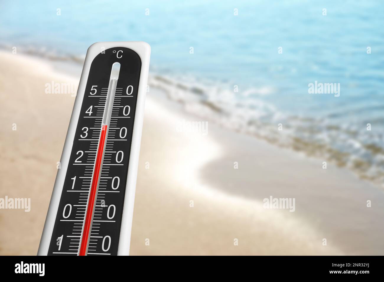 Weather thermometer and beautiful seashore. Heat stroke warning Stock ...