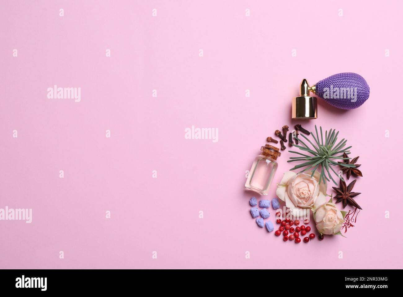 Bottle of luxury perfume and different ingredients on pink background ...