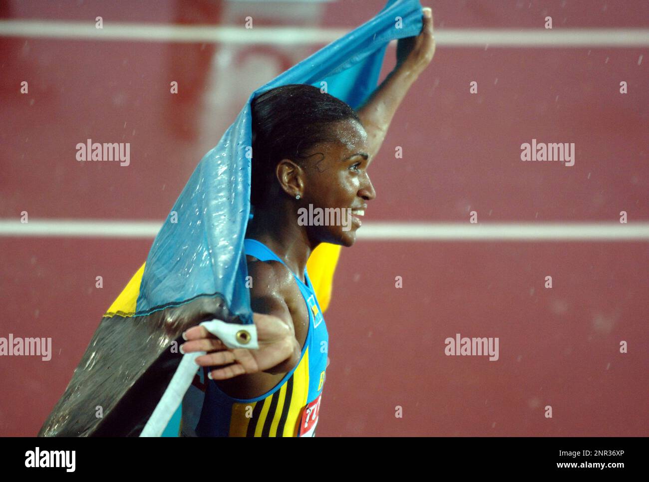 Tonique Williams-Darling of The Bahamas celebrates with a flag after ...