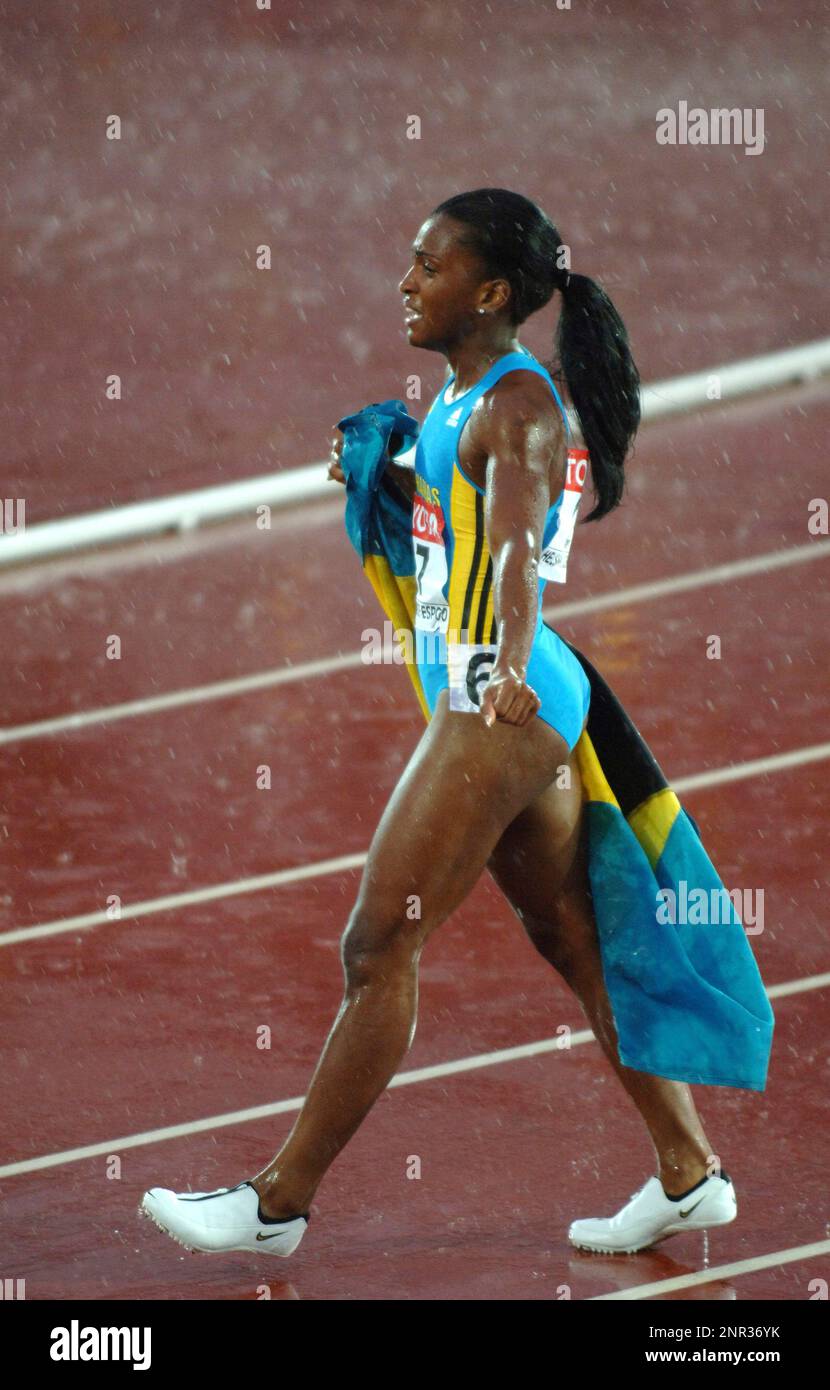 Tonique Williams-Darling of The Bahamas celebrates with a flag after ...