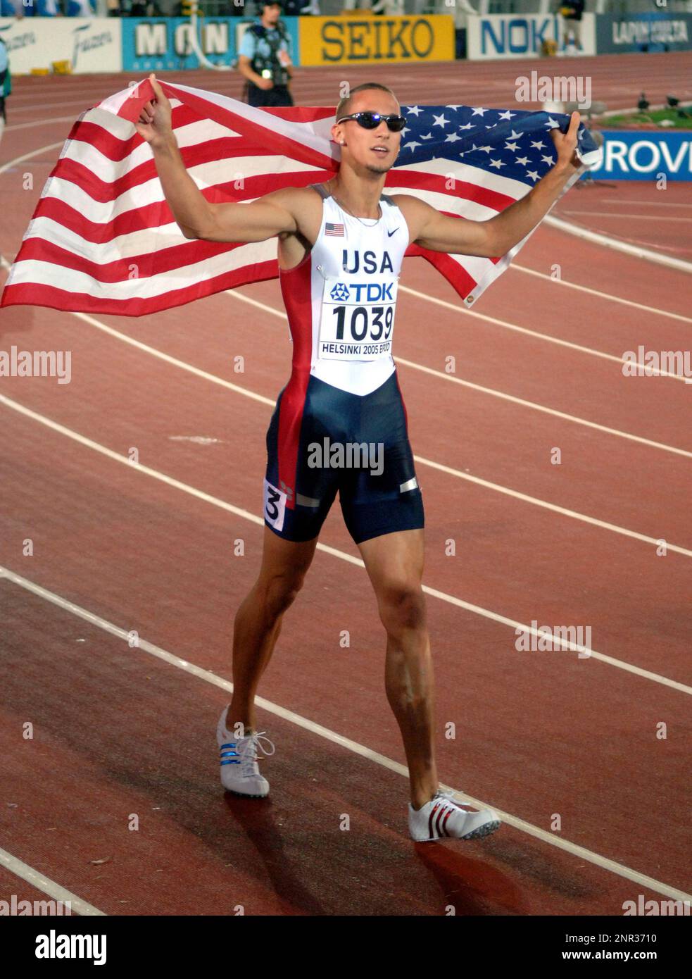 Jeremy Wariner of the United States takes a victory lap wiht American ...