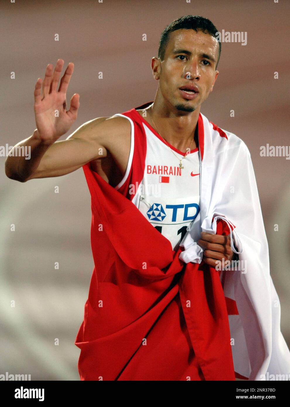 Rashid Ramzi of Bahrain takes a victory lap with flag after winning the ...