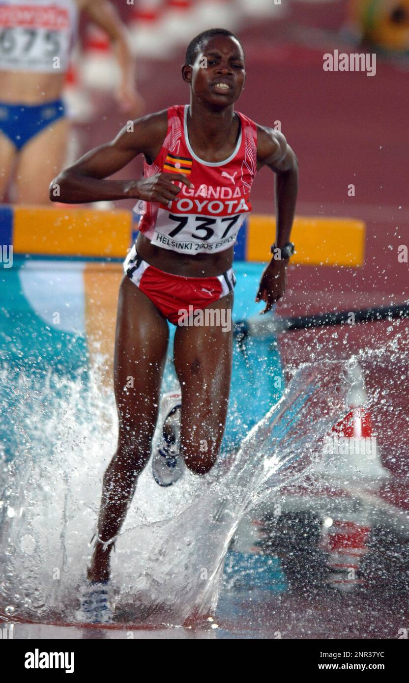 Docus Inzikuru of Uganda negotiates the water jump en route to winning ...