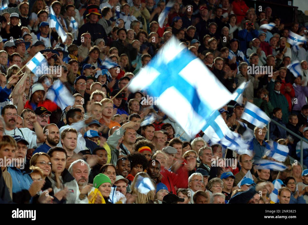 Spectators wave Finland flags during the men's long jump final in the ...