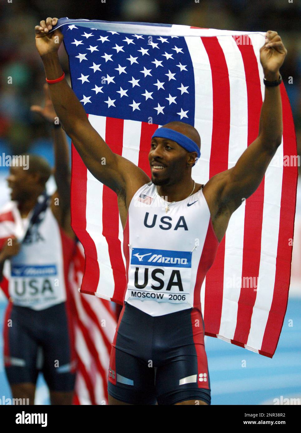Tyree Washington poses with an American flag after running the leadoff ...