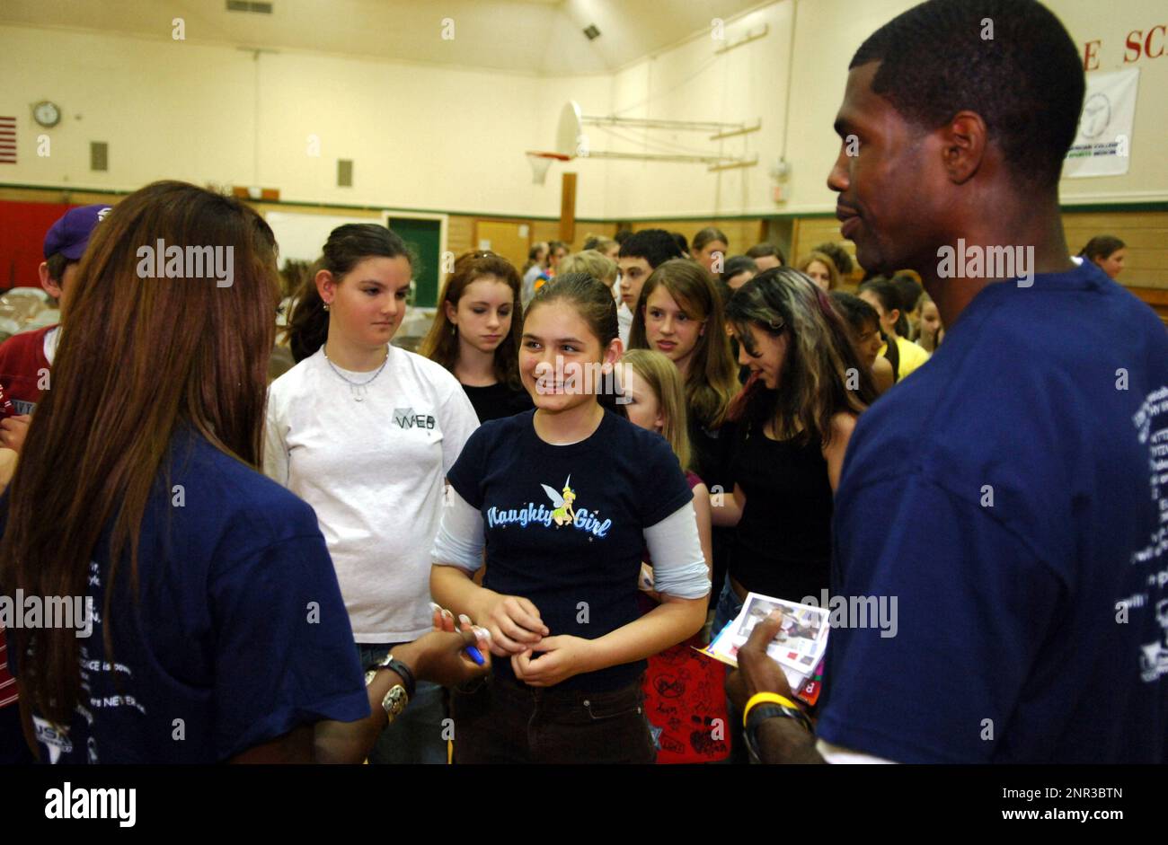 Danielle Carruthers and Derrick Brew sign autographs for students at ...
