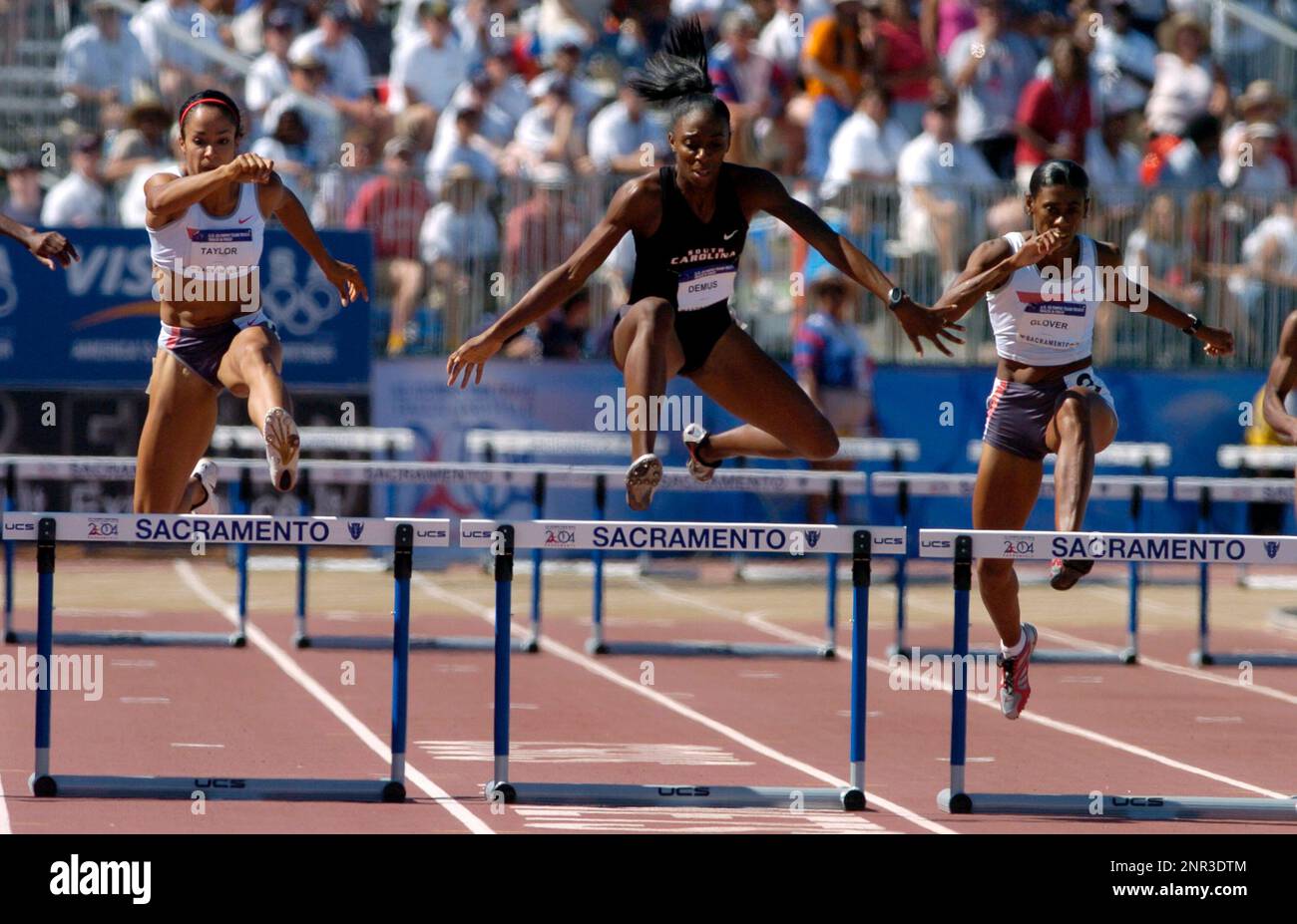 Lashinda Demus (center) clears the final hurdle in the women's 400 ...