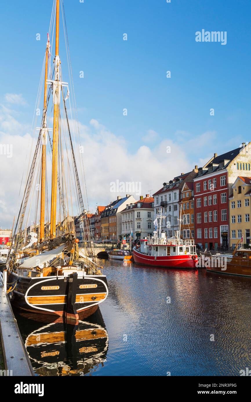 Moored boats and colourful 17th century apartment buildings and houses ...