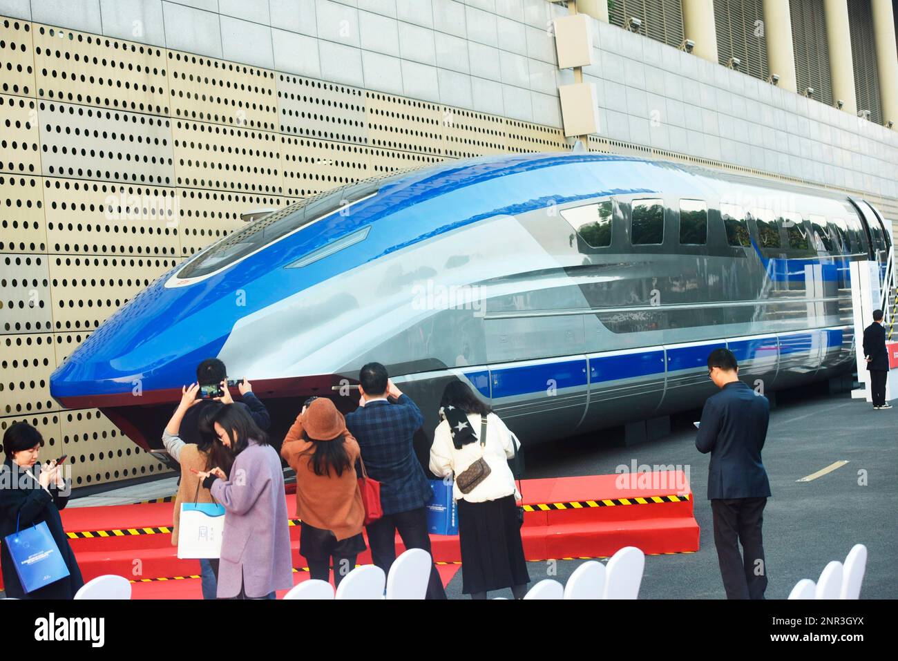 Visitors look at the prototype of the 600km/h maglev train made by CRRC ...