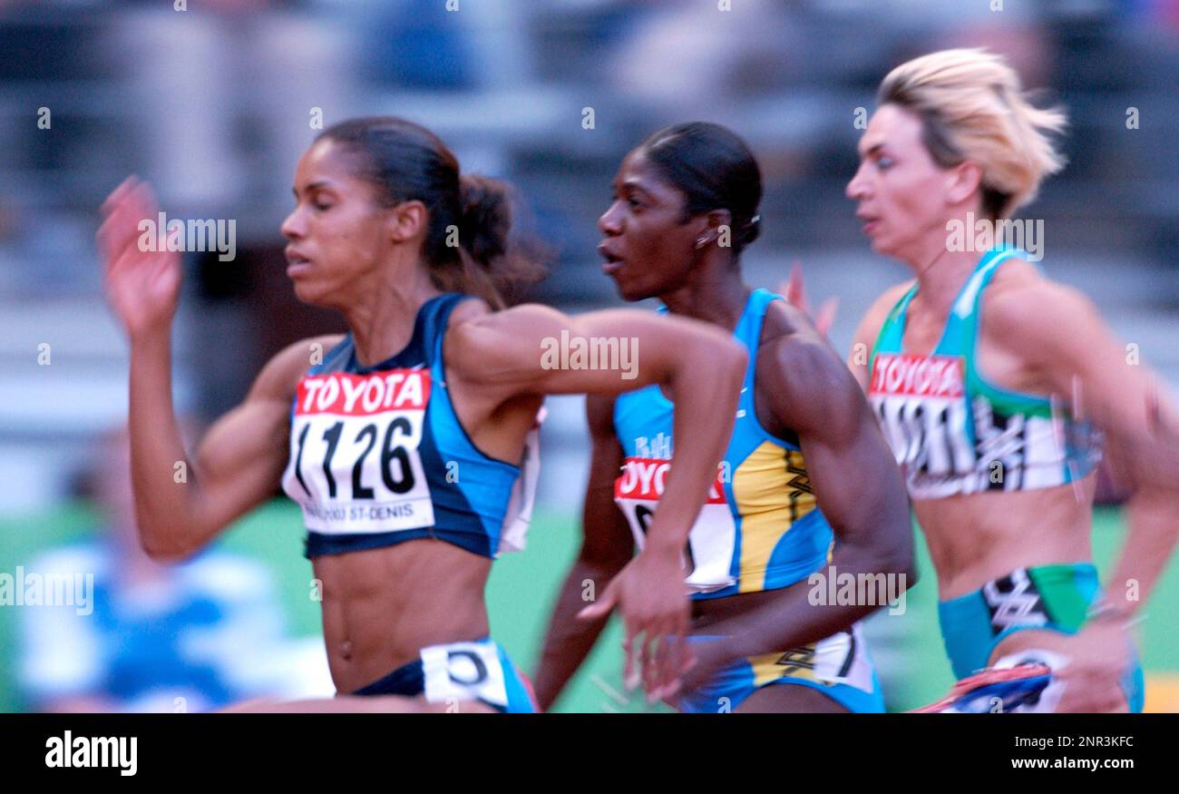 Torri Edwards of the United States (left) wins 100-meter quarterfinal ...