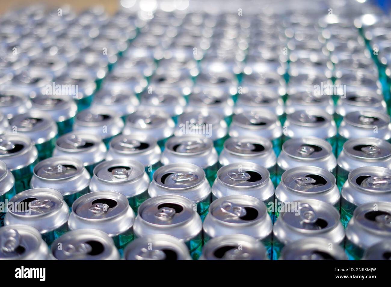 Hundreds of empty cans of beer are the result of making bottles of hand ...