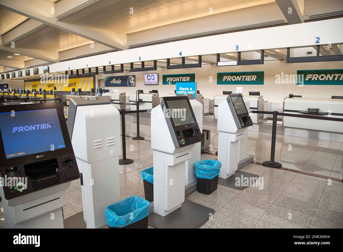 The Frontier Airlines self check-in kiosks are empty as the ticket ...