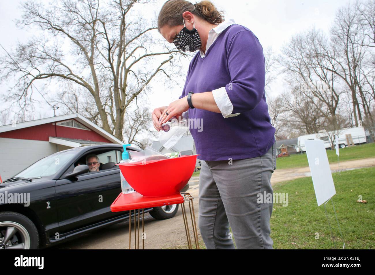Pastor Jennifer Zoller hands out communion wine and wafers during a ...