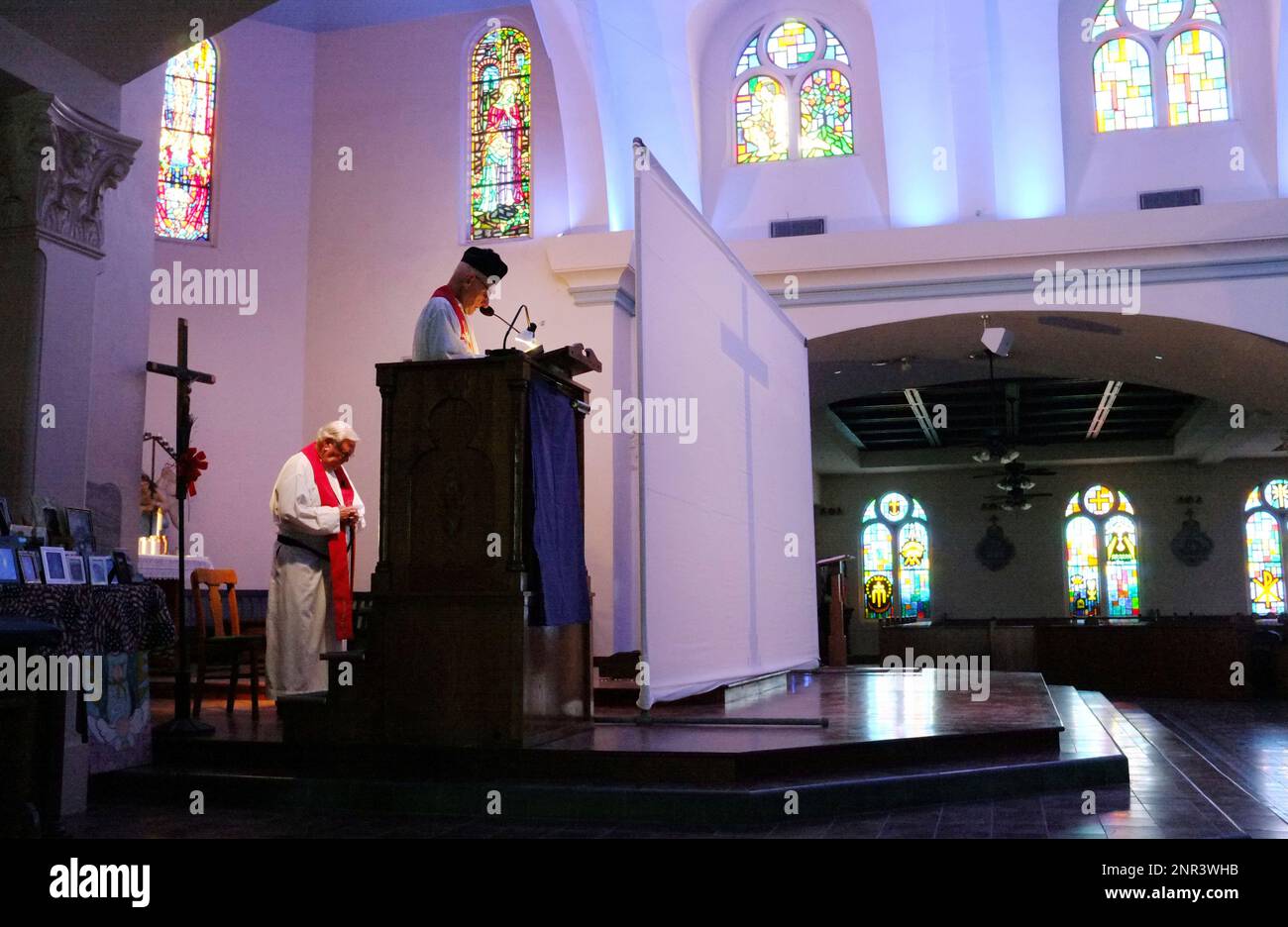 The Rev. Roy Snipes bows his head as the Rev. Richard Philion and a ...