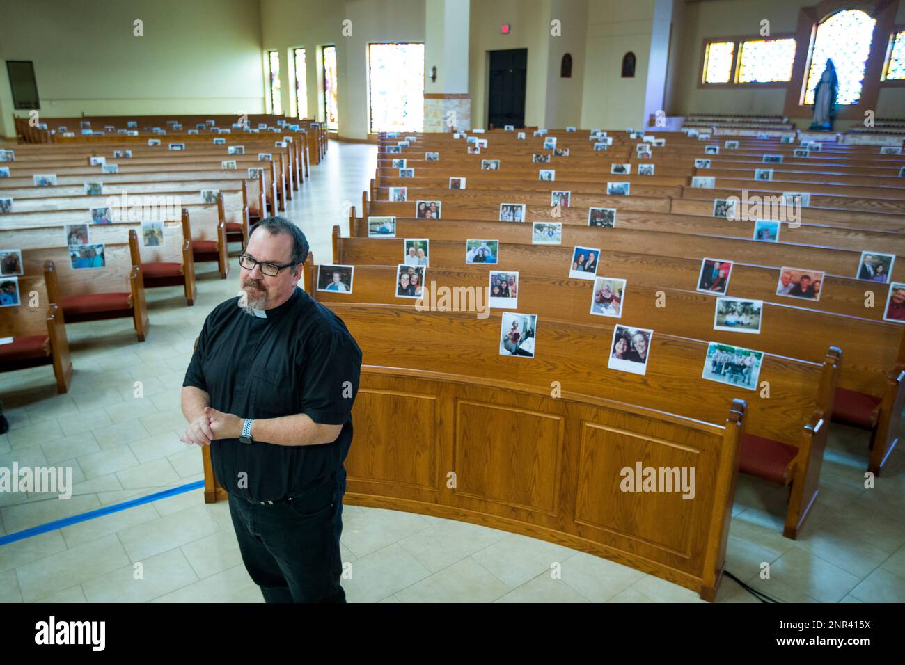 The Rev. Sean Horrigan, parish priest, stands in the sanctuary at ...