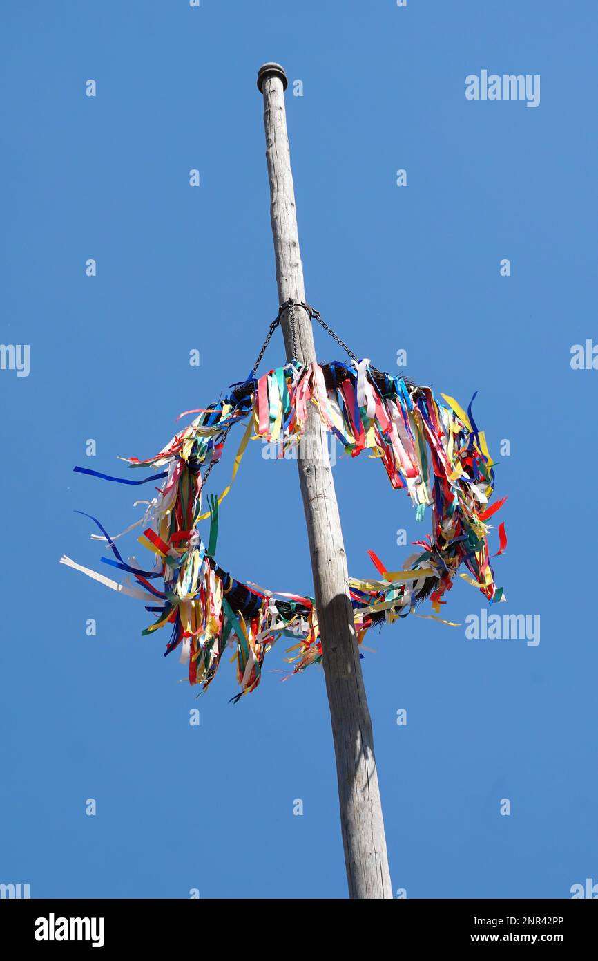traditional german maypole against blue sky, may day celebration in ...