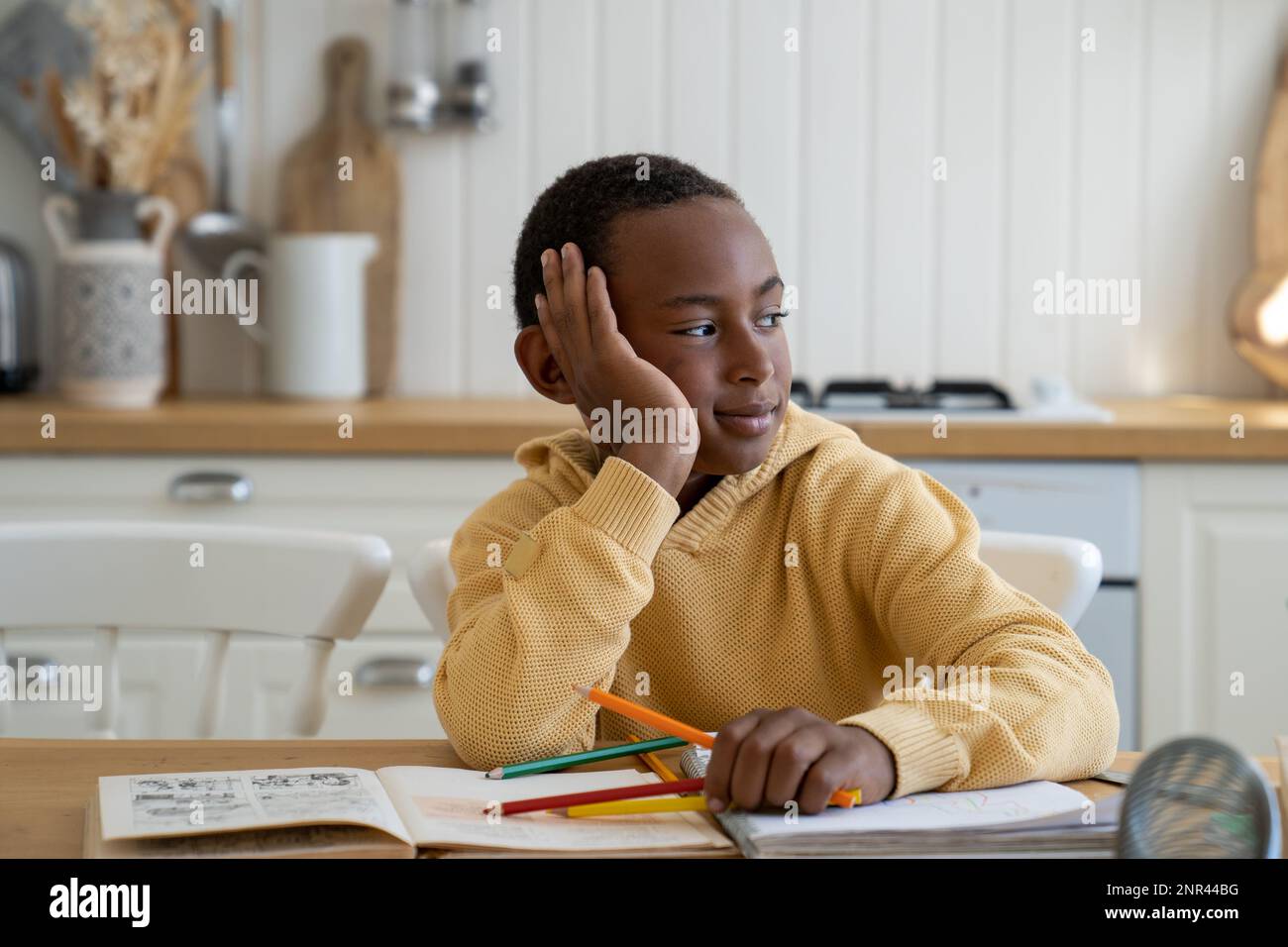 Cute pensive biracial child boy look side at window distracted from ...