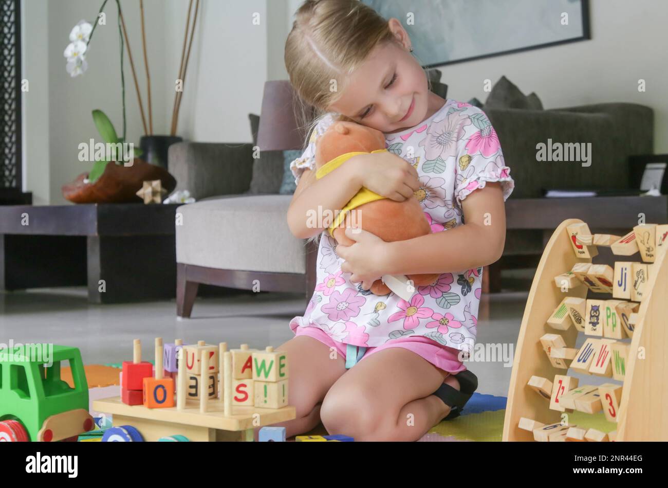 Adorable little girl hugging her teddy bear Stock Photo - Alamy