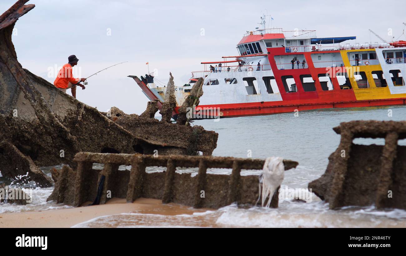 A Passing Ferry And A Fisherman Standing On A Sunken Shipwreck, On The ...